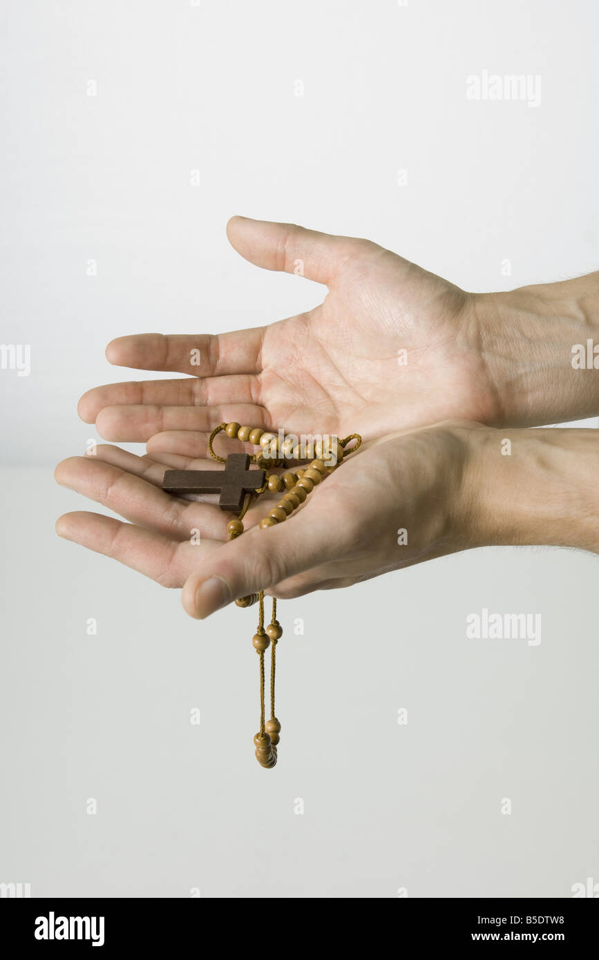 Hands holding rosary Stock Photo - Alamy