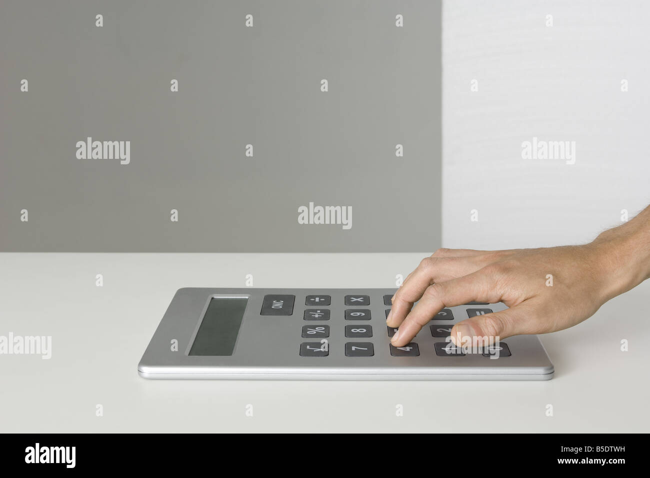 Hand using oversized calculator Stock Photo - Alamy