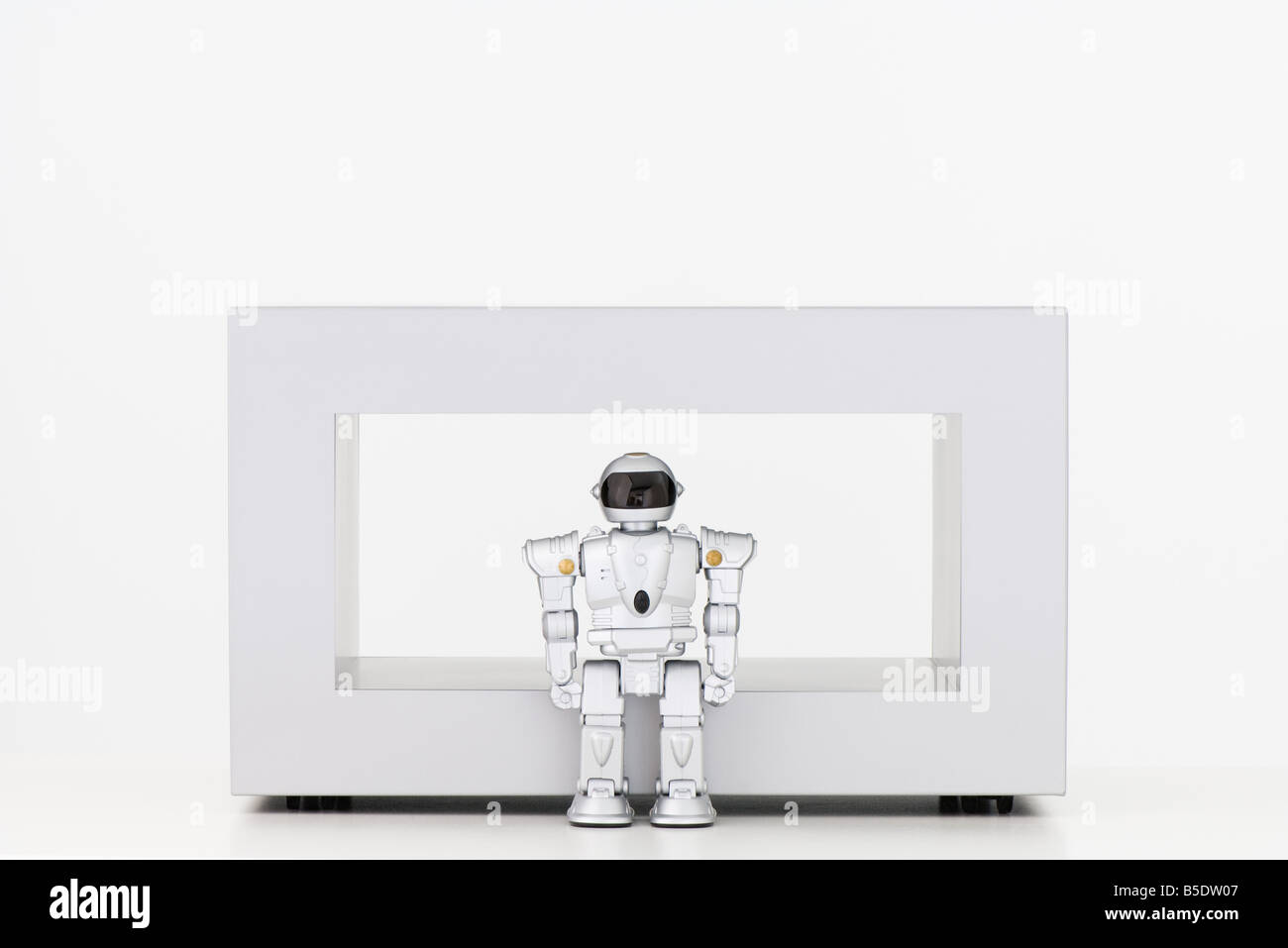 Toy robot standing in front of coffee table Stock Photo - Alamy