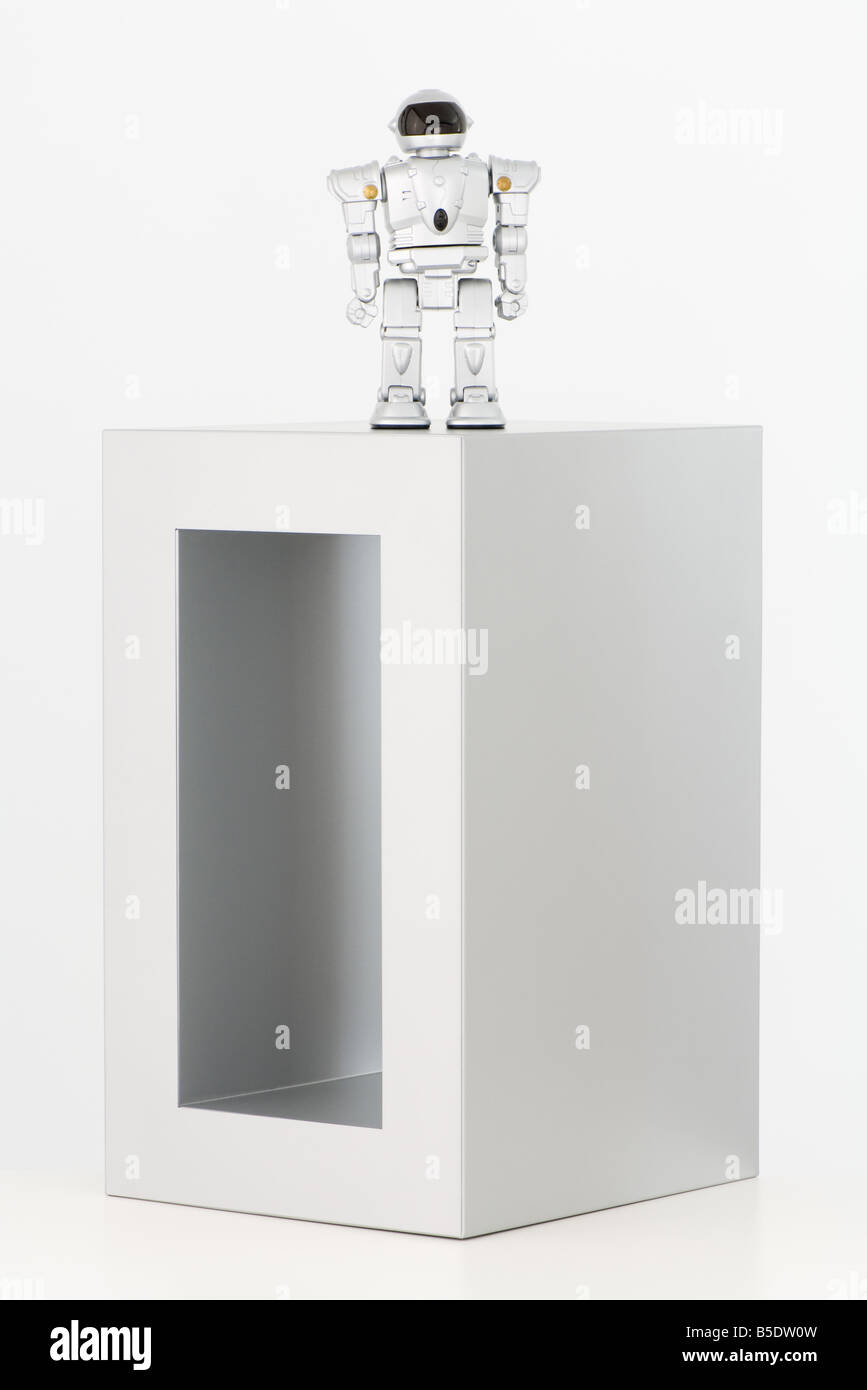 Toy robot standing on top of box Stock Photo - Alamy