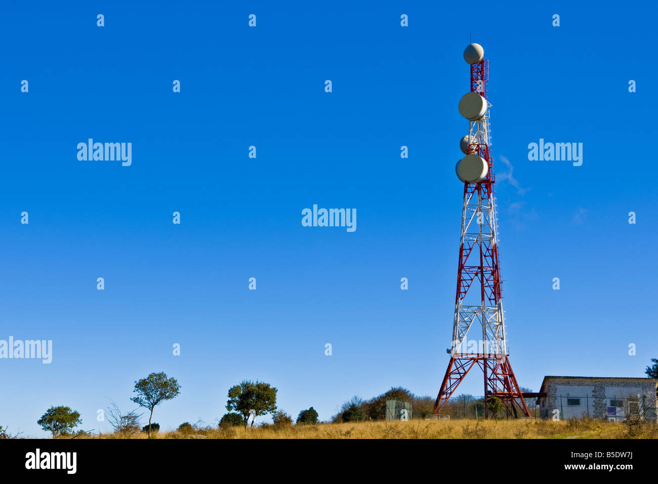 Telecommunications tower with parabolic antennas over a blue sky Stock ...