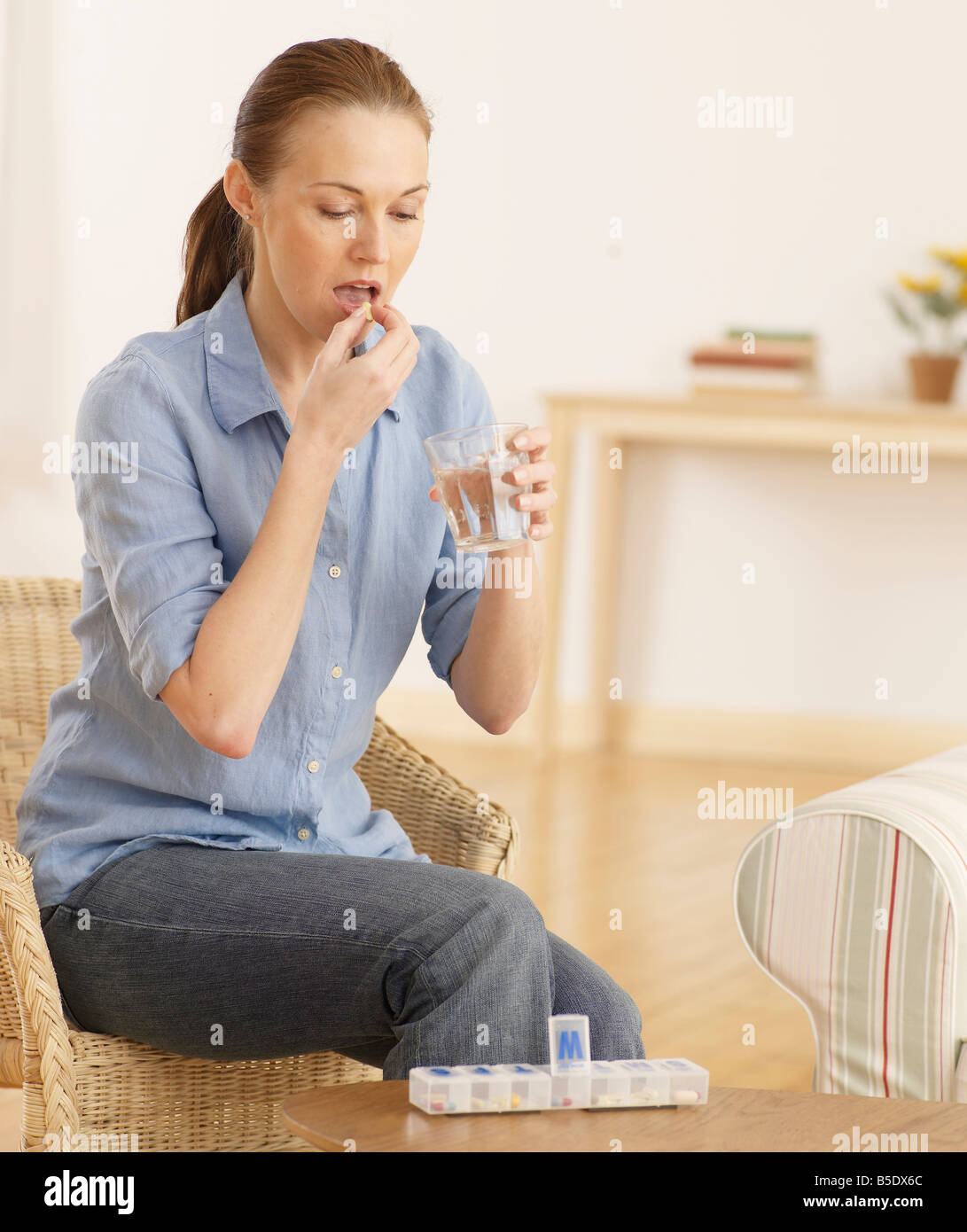 Mid-Adult Woman Taking Medicine Stock Photo - Alamy