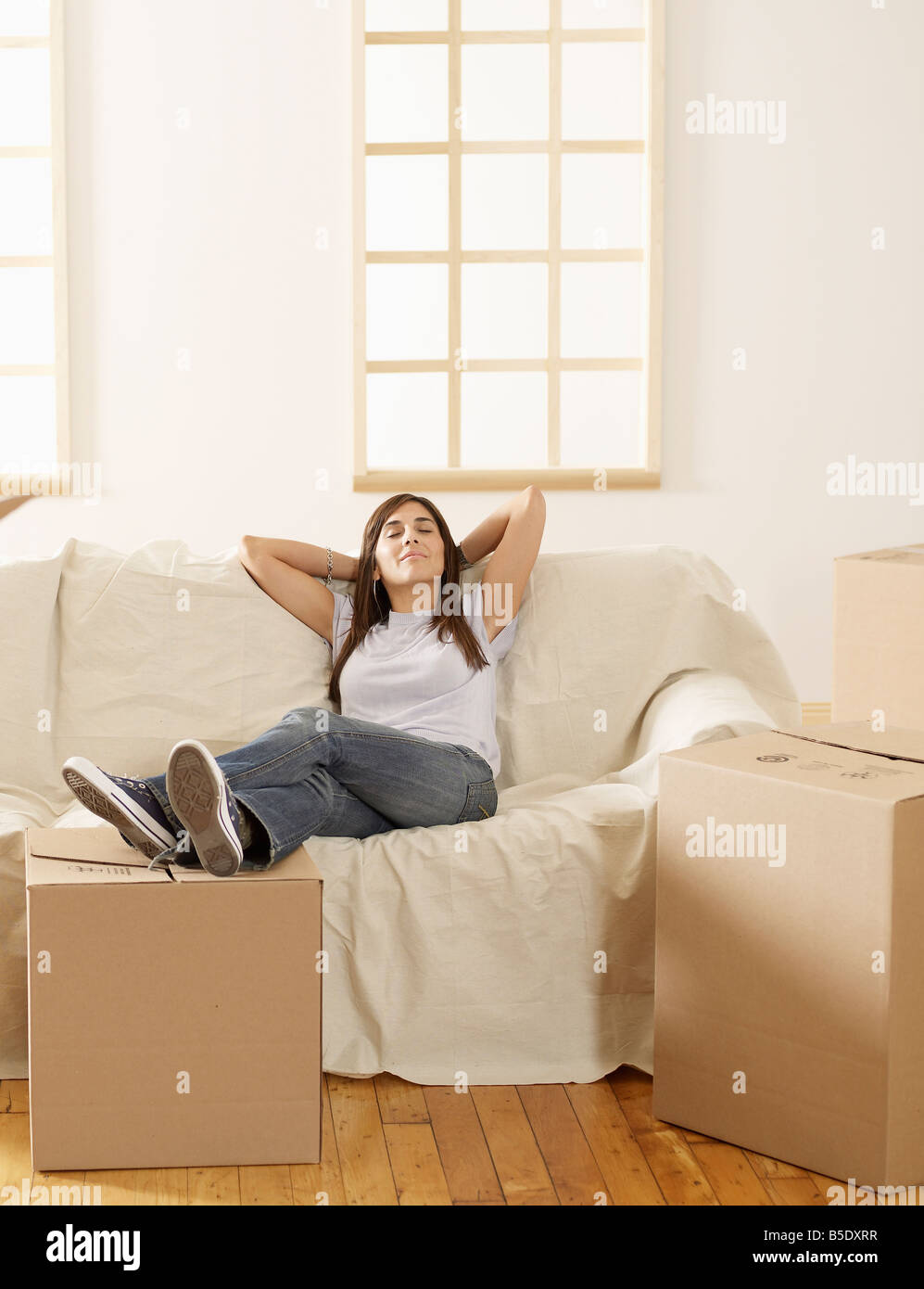 Woman Resting by Cardboard Boxes Stock Photo - Alamy