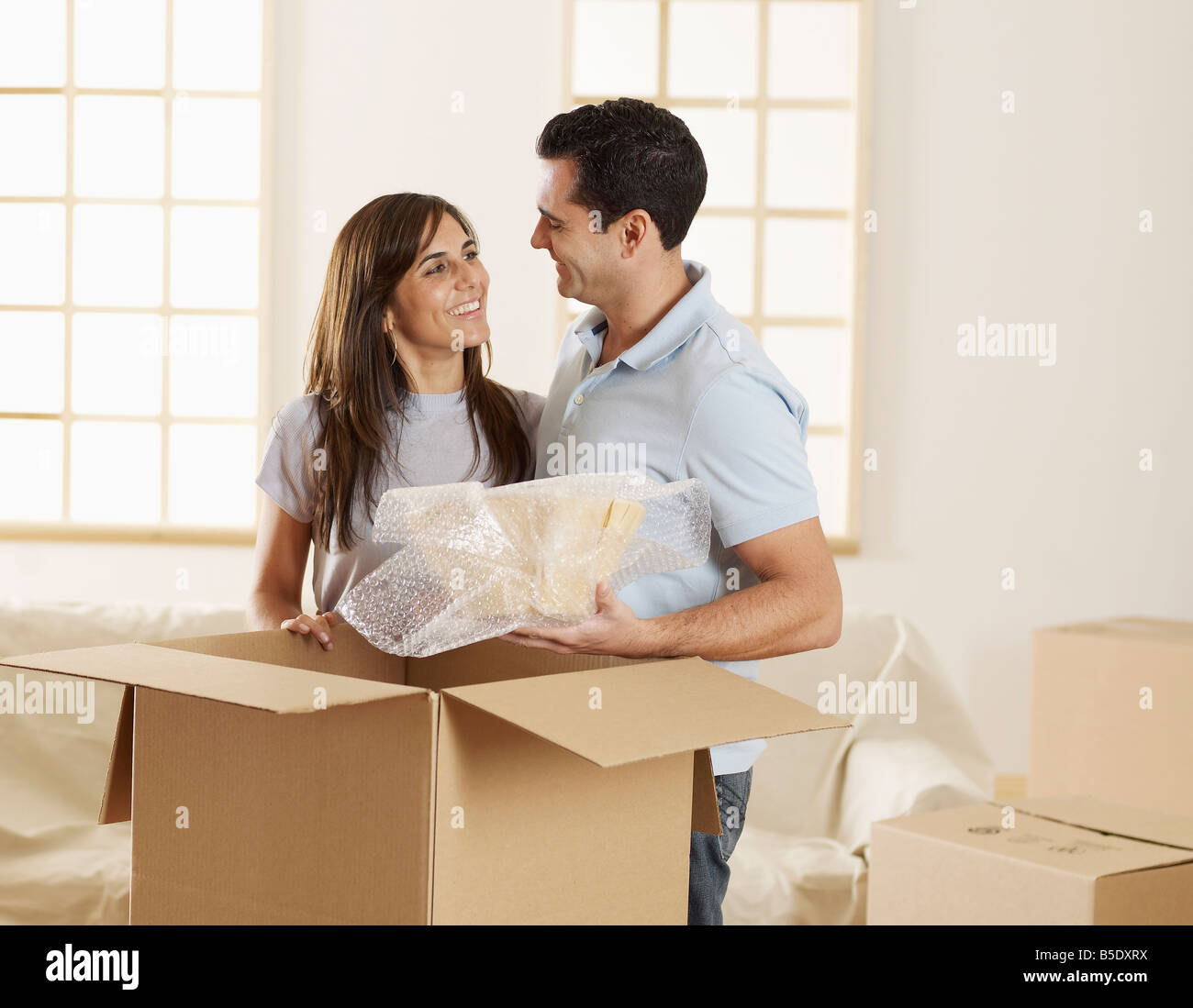 Couple Unpacking Cardboard Boxes Stock Photo - Alamy
