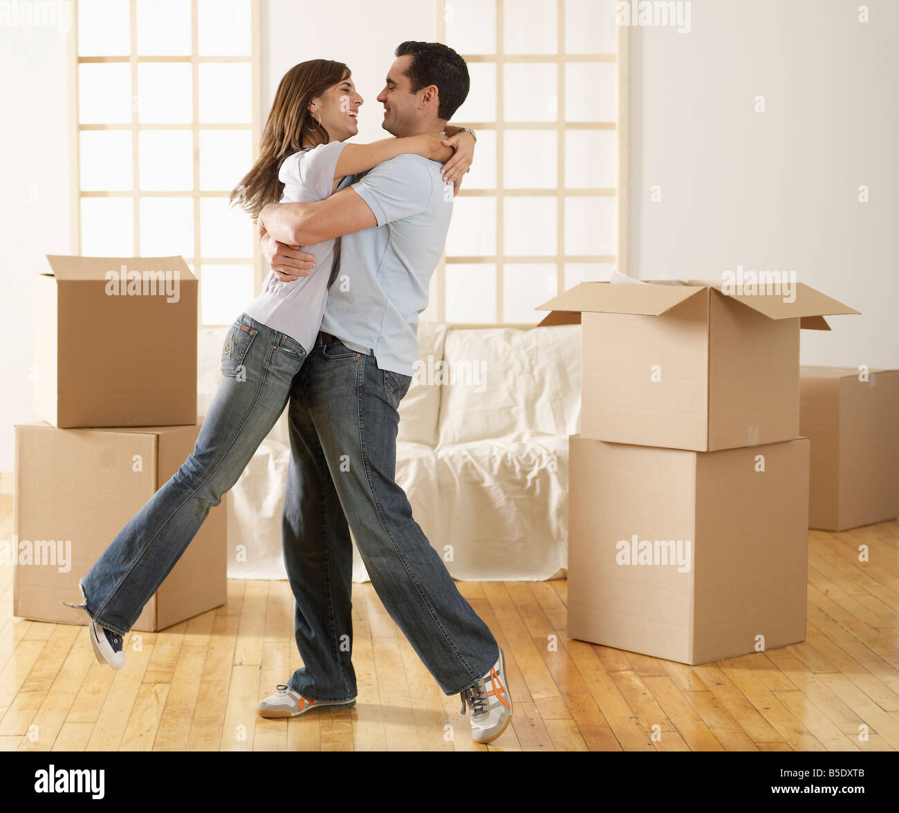Couple Hugging by Cardboard Boxes Stock Photo - Alamy