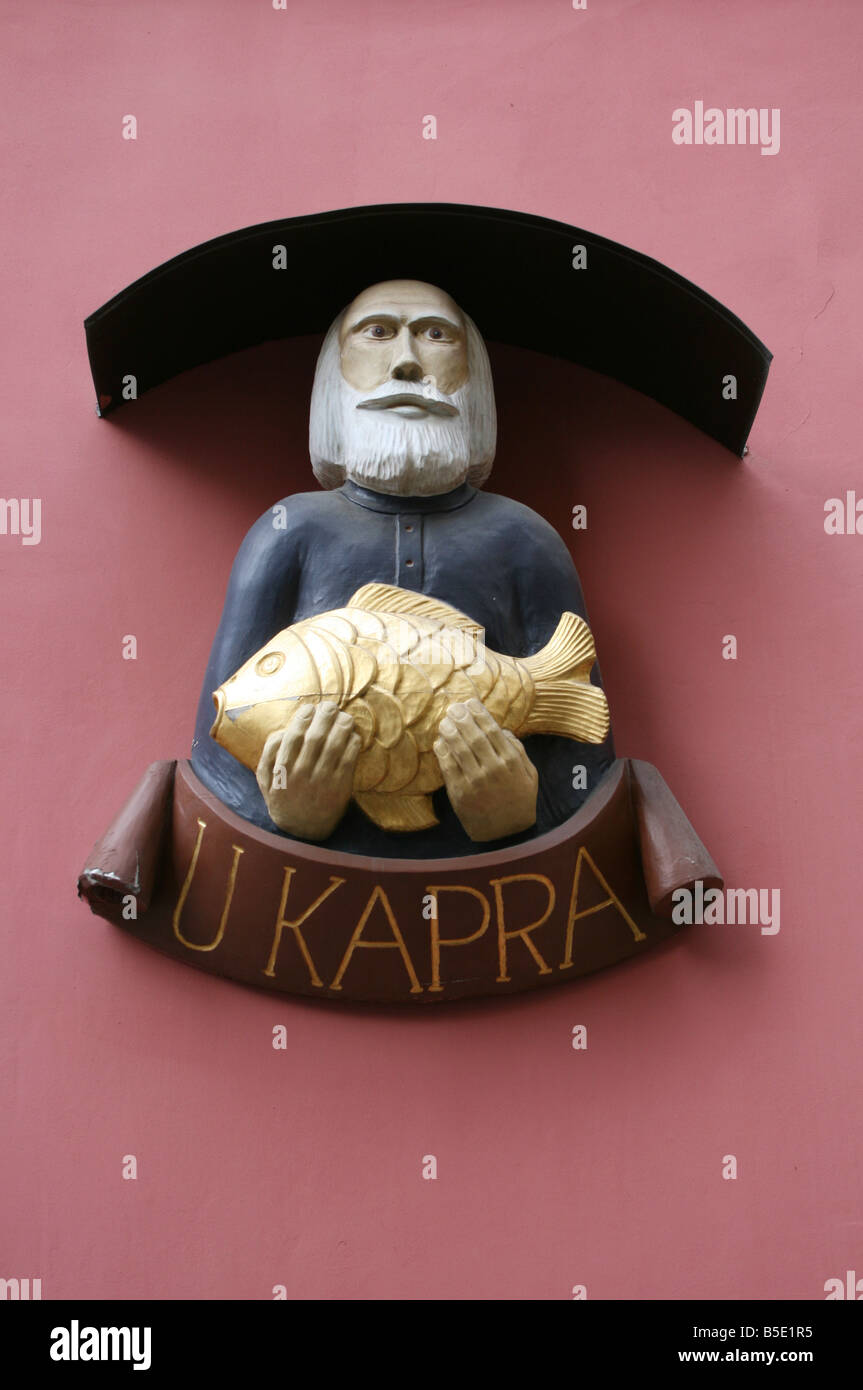 man holding fish statue on wall Prague Czech Republic June 2008 Stock ...
