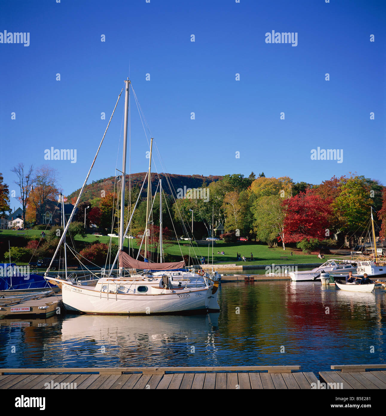 Boats on the waterfront at Camden harbour with fall colours and Mount ...