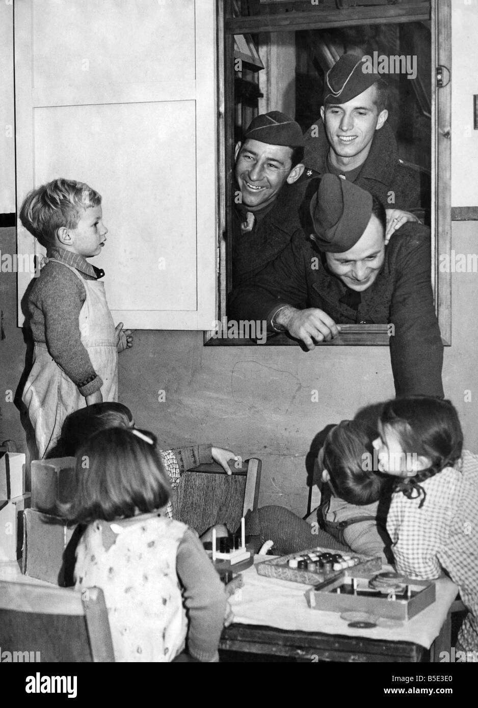 Soldiers with children in a nursery during World war two November 1942 ...