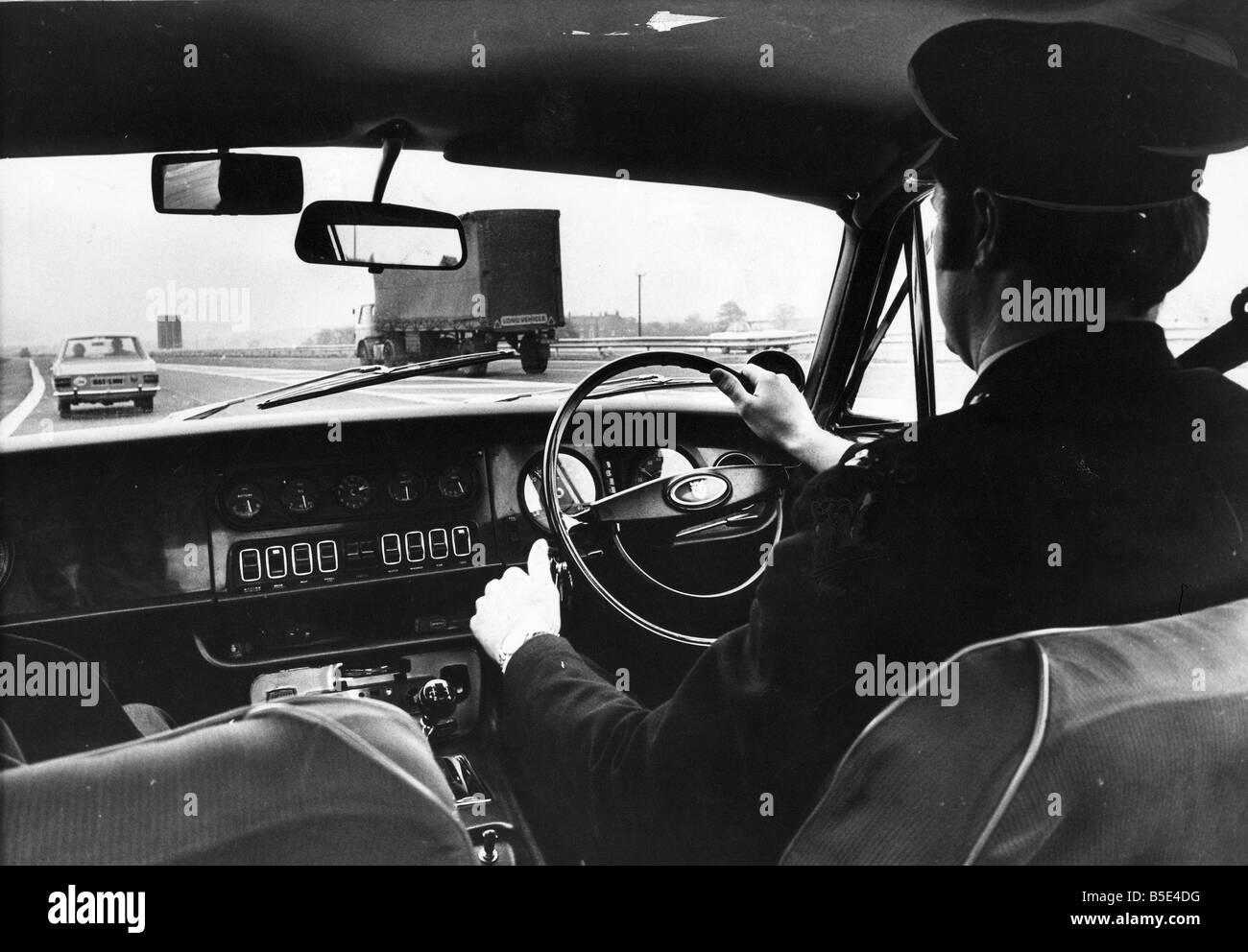 A police officer watching the traffic in his police car Stock Photo - Alamy