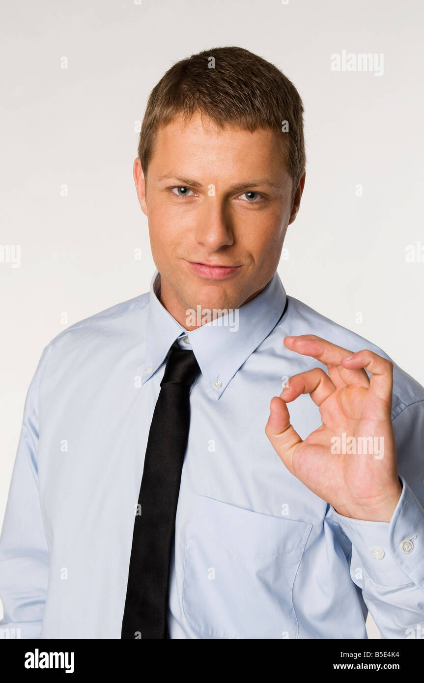 Businessman making ok sign, portrait Stock Photo - Alamy