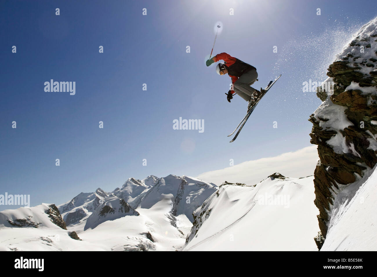 Italy, Tyrol, Monte Rosa, Freeride, Man jumping on skis, low angle view ...
