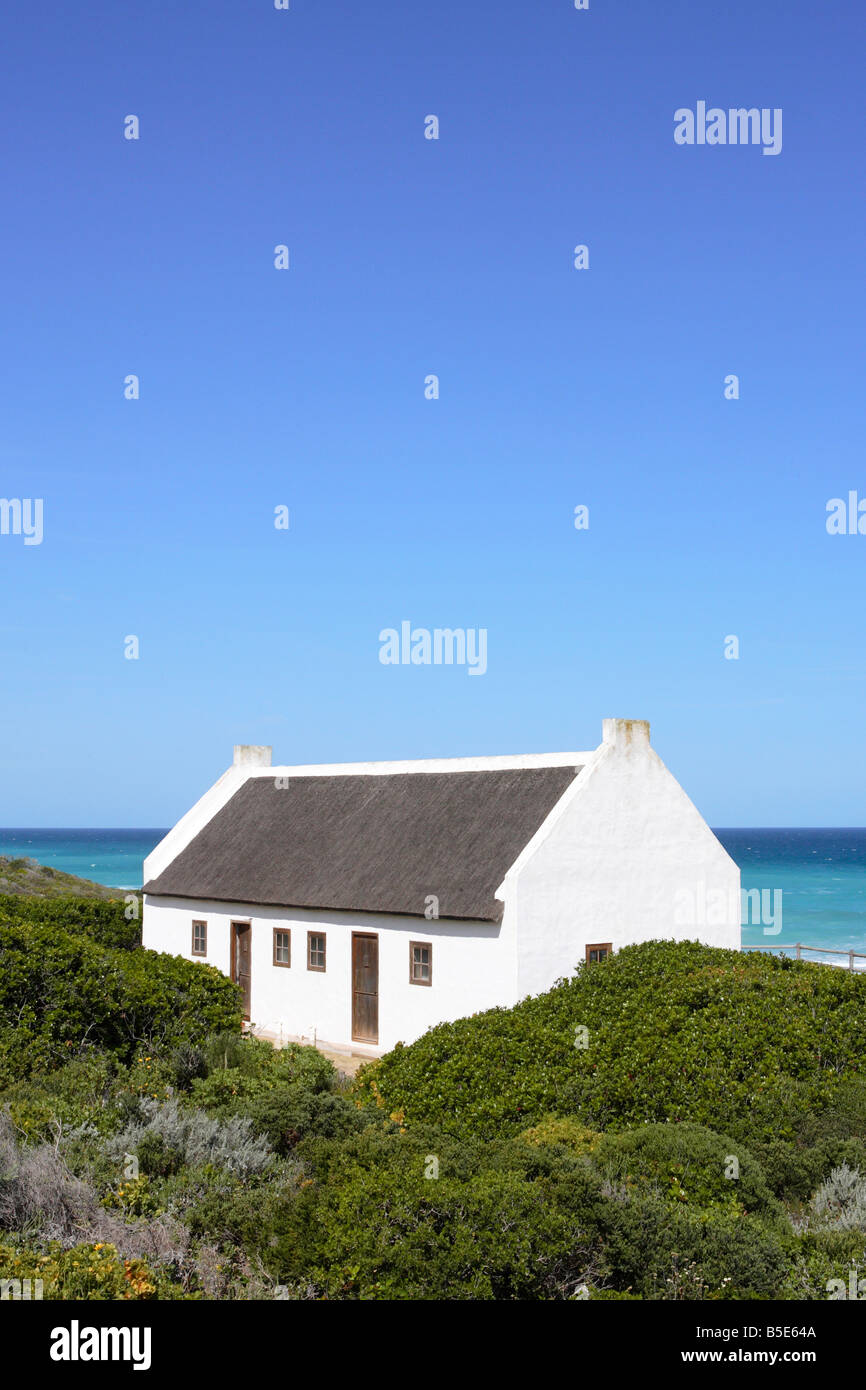 Solitary house looking out to sea surrounded by thick fynbos - De Hoop ...