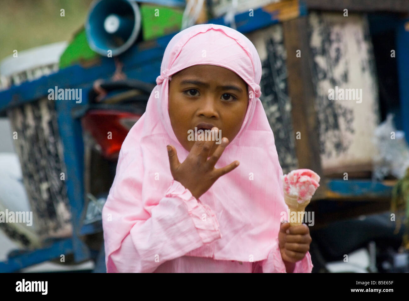 Muslim Girl Eating Ice Cream in Sapit on Lombok Island in Indonesia ...