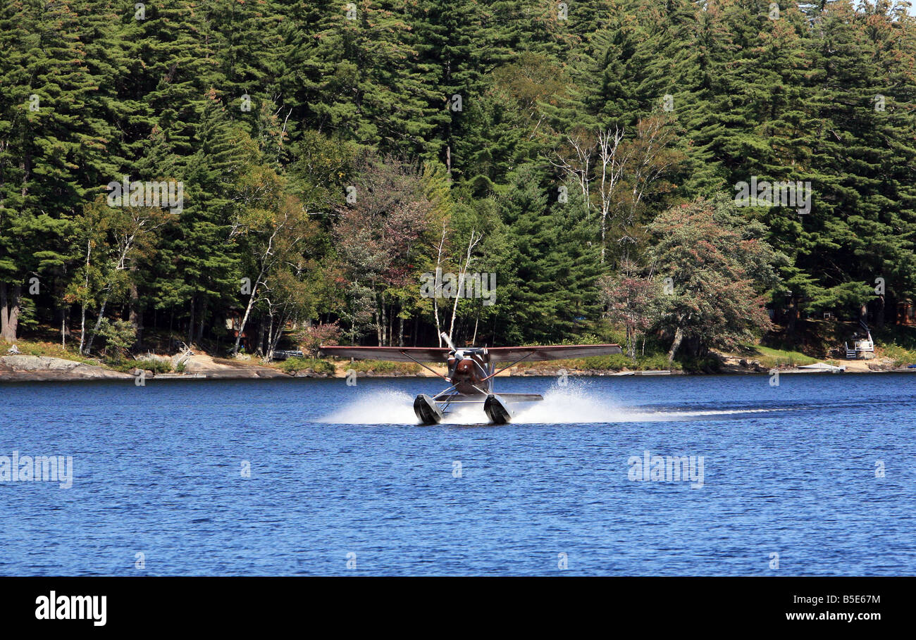 A single engine float plane landing on Long Lake New York Stock Photo ...