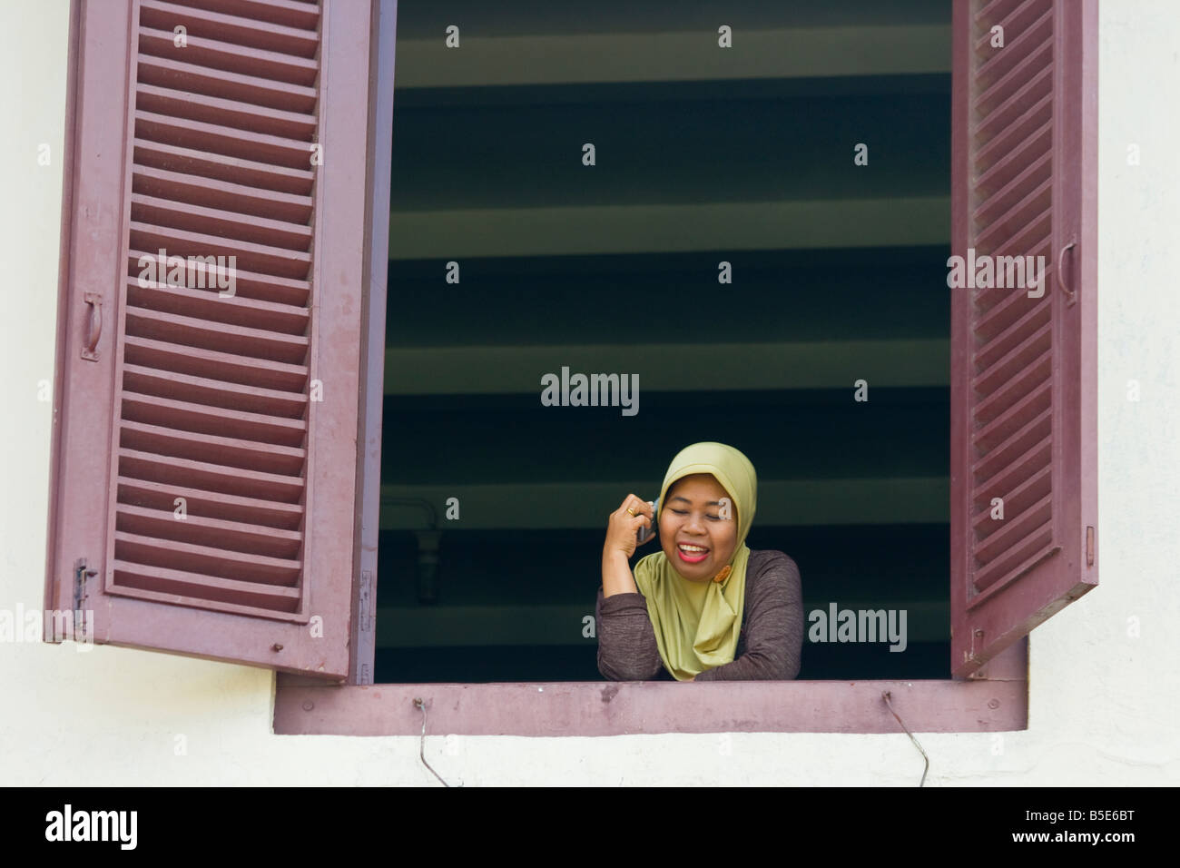 Indonesian Woman Using a Mobile Phone in Fort Rotterdam in Makassar on ...