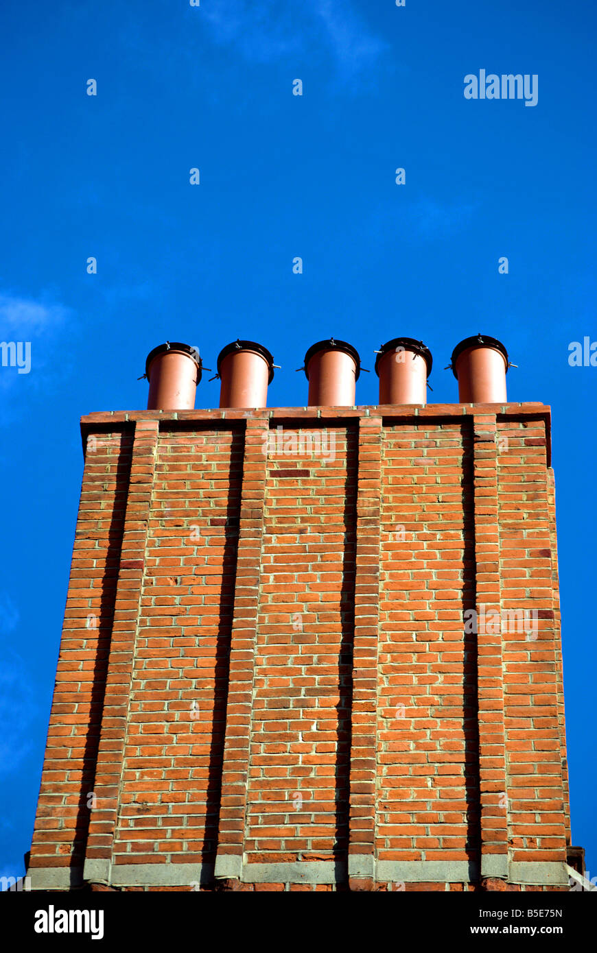 five capped chimneys rising froma redbrick stack, in chelsea, london ...