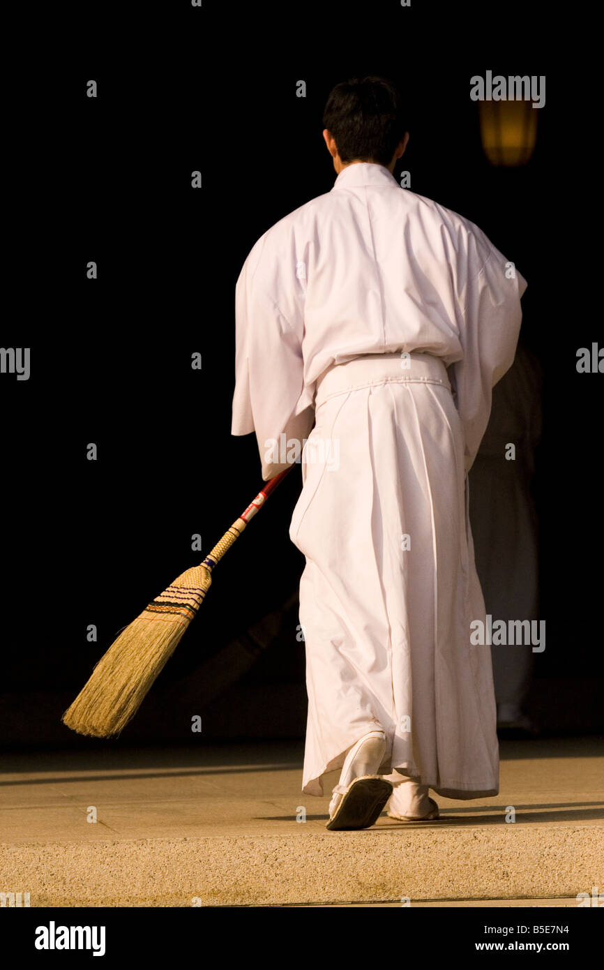 A Shinto monk sweeps the Meiji Temple in Tokyo, Japan Stock Photo - Alamy