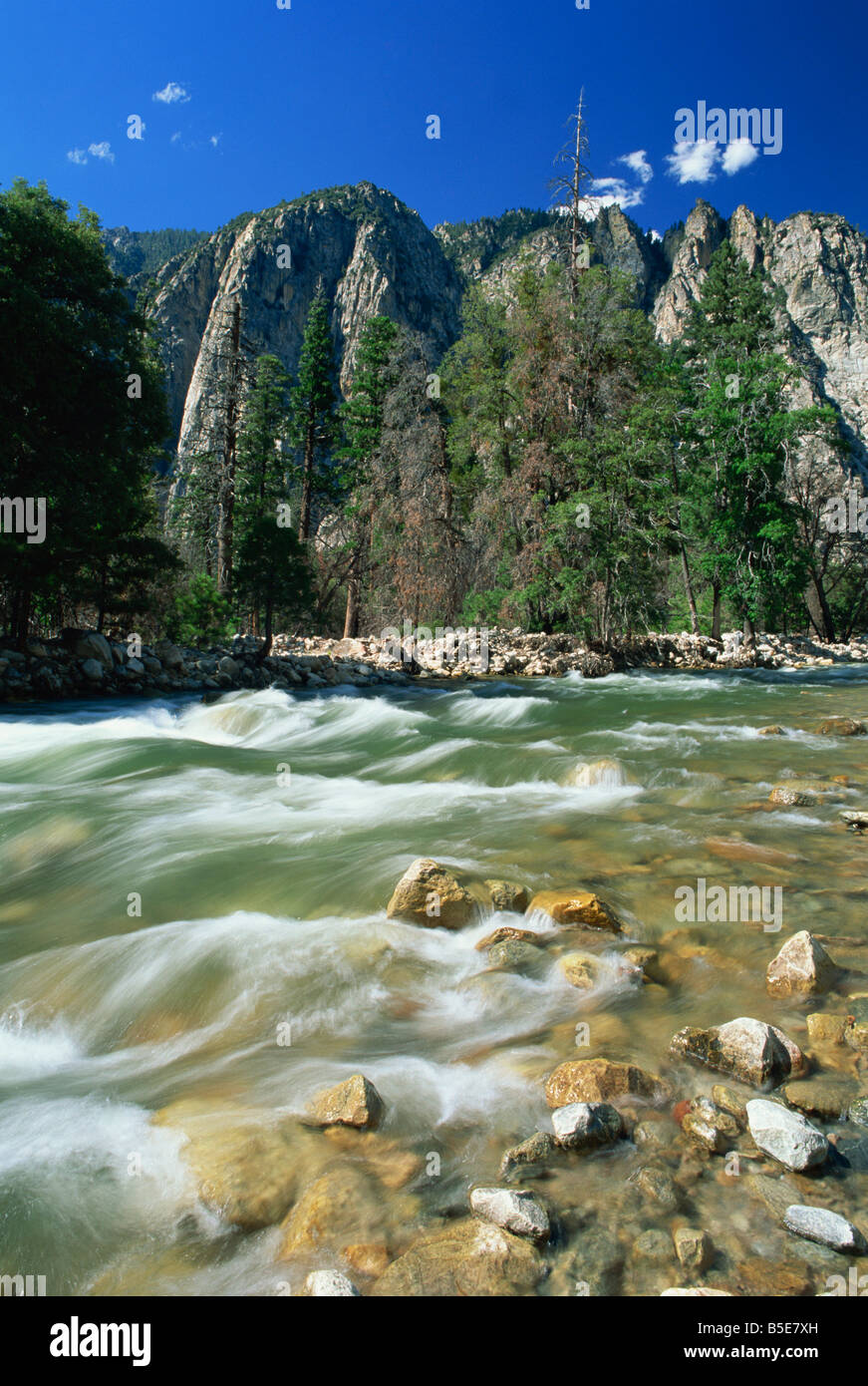 Rocks in the South Fork of the Kings River with trees and crags in the ...