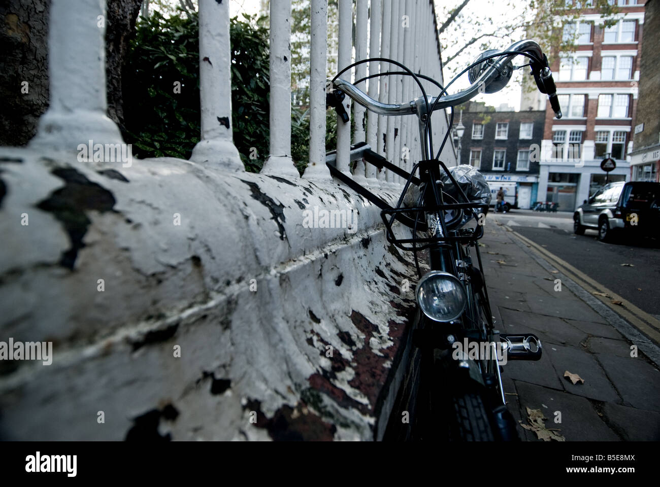 An oldstyle biked leaned up against railings Stock Photo - Alamy
