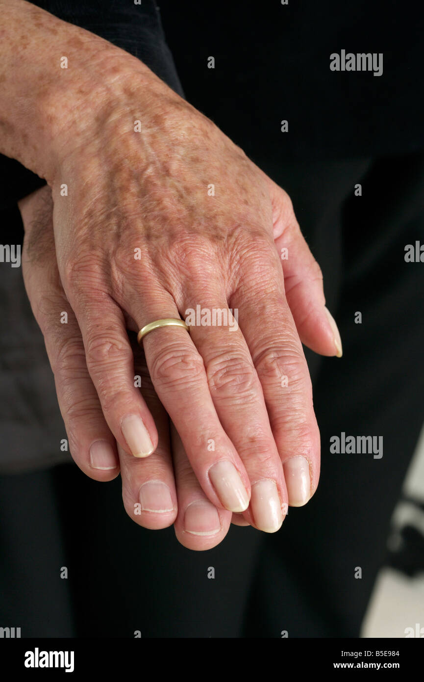 Two hands lying upon each other Stock Photo - Alamy
