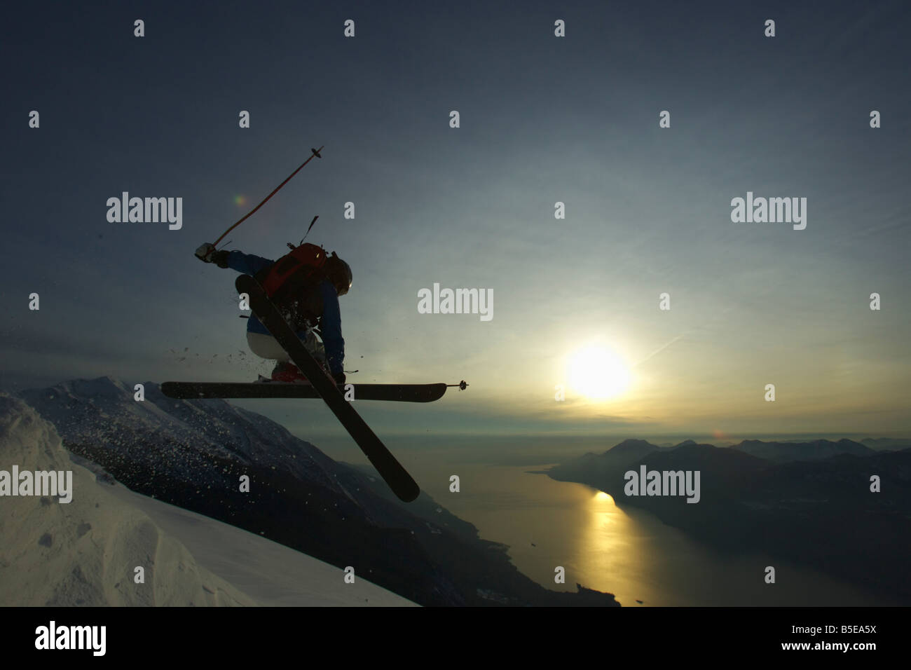 Jumping skier in front of sunset Stock Photo - Alamy