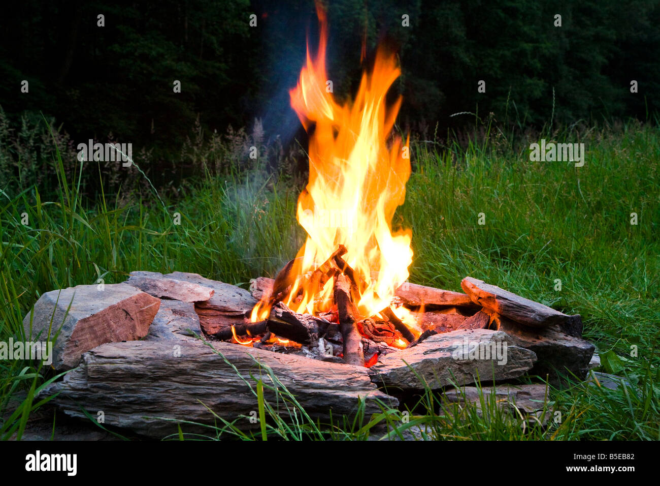 Campfire at twilight Stock Photo - Alamy