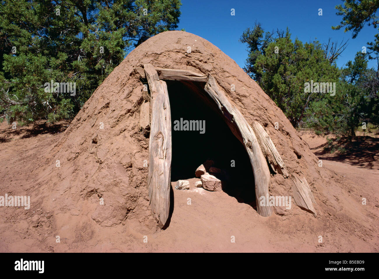 A Navaho steam bath where water is sprinkled on hot rock for steam and ...