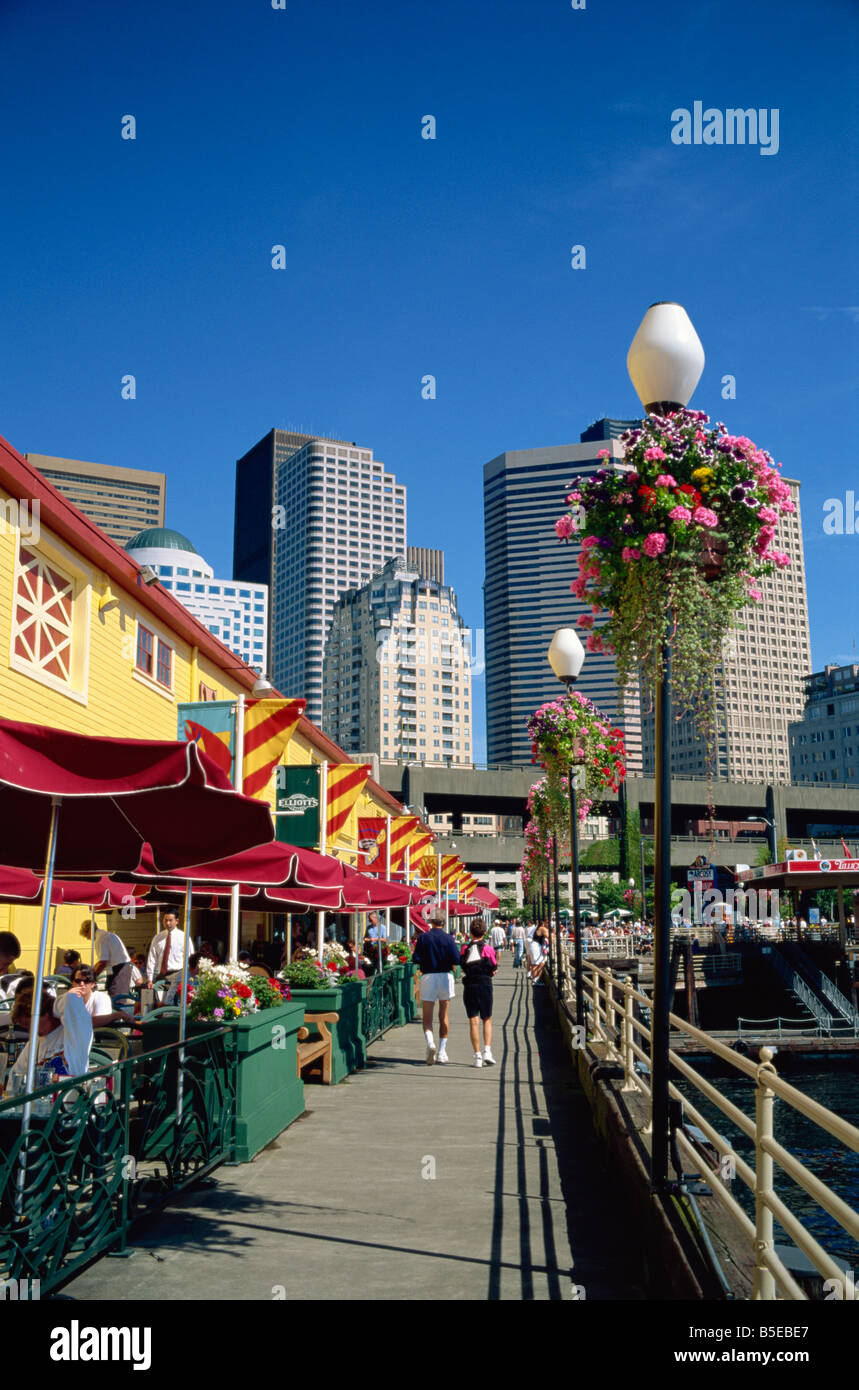 Cafes on Pier 56 on the waterfront with tower blocks of the city in the ...