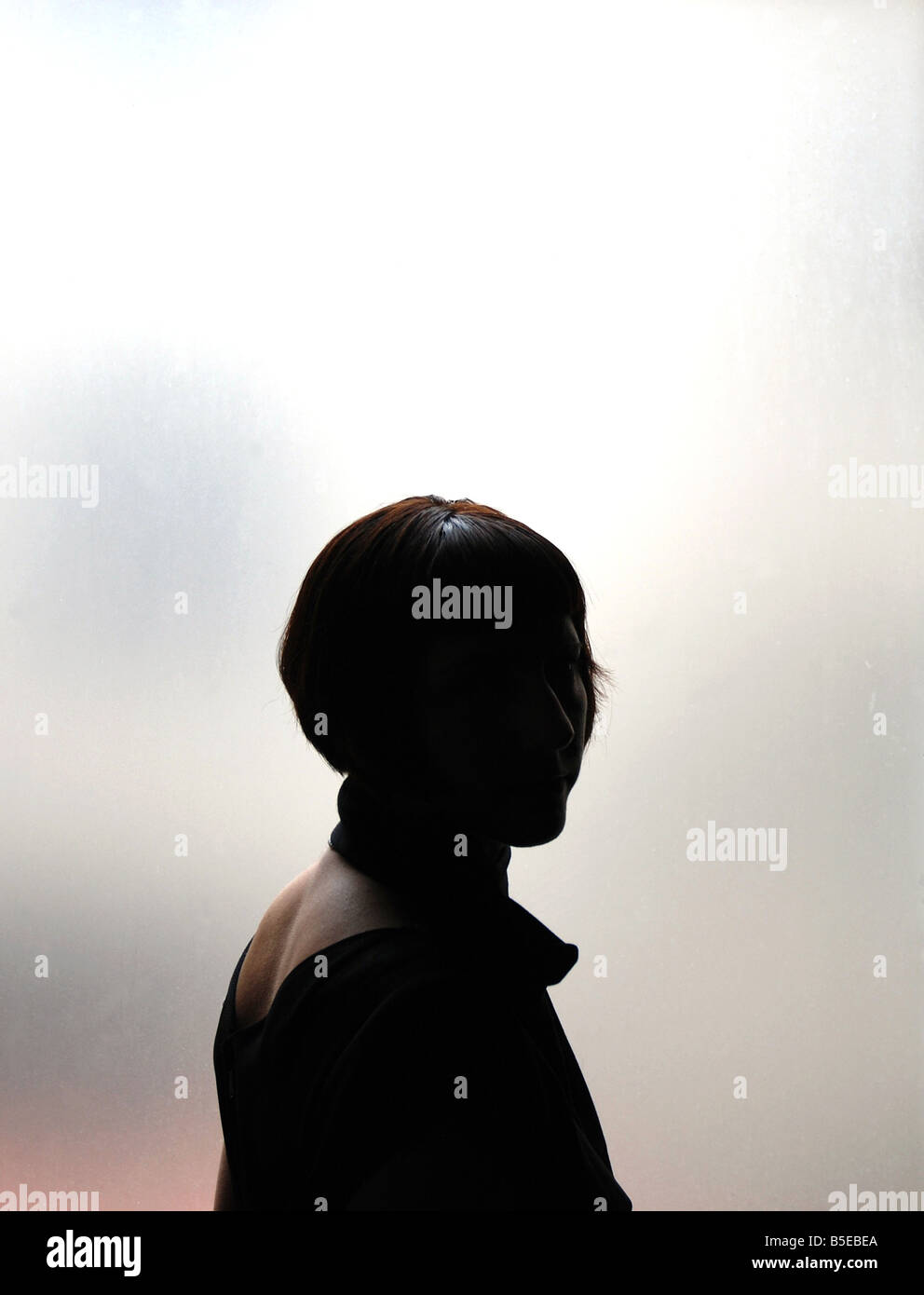 Profile of a young woman in shadows Stock Photo - Alamy