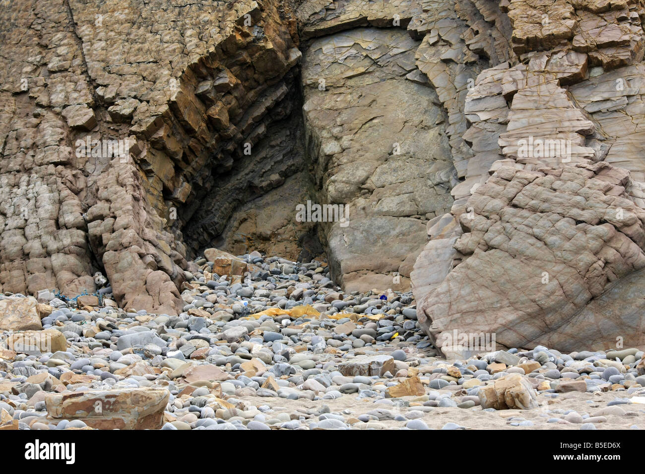 A small sea cave with interesting rock formations Stock Photo - Alamy
