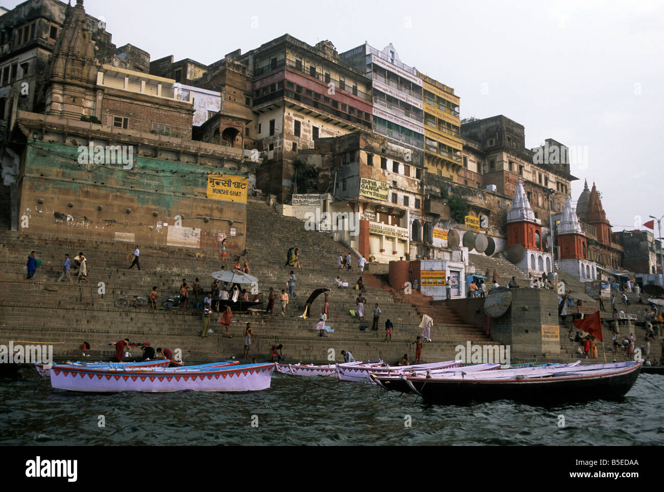 At the Munshi Ghat on the sacred Ganges River, Varanasi, India, people ...