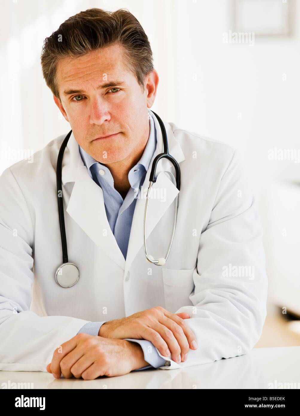 doctor at desk in office Stock Photo - Alamy