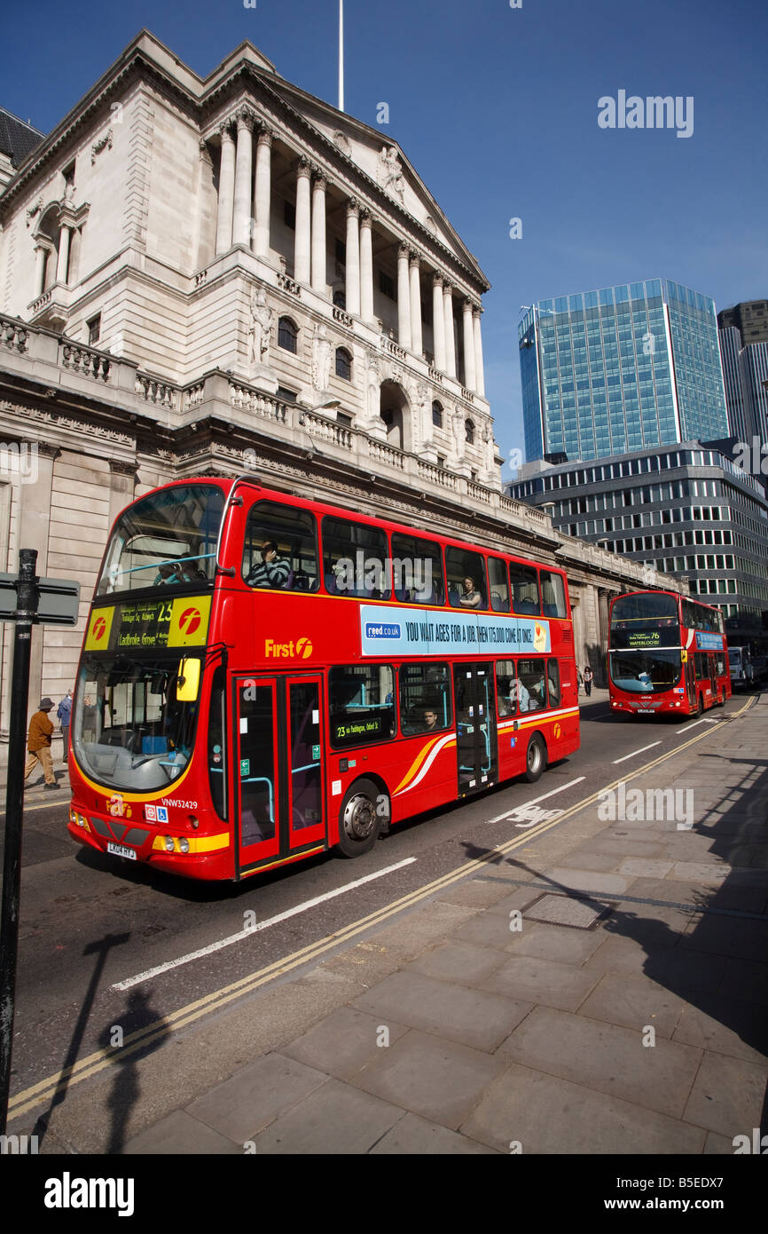 Bank of England London and red London double decker buses Stock Photo ...