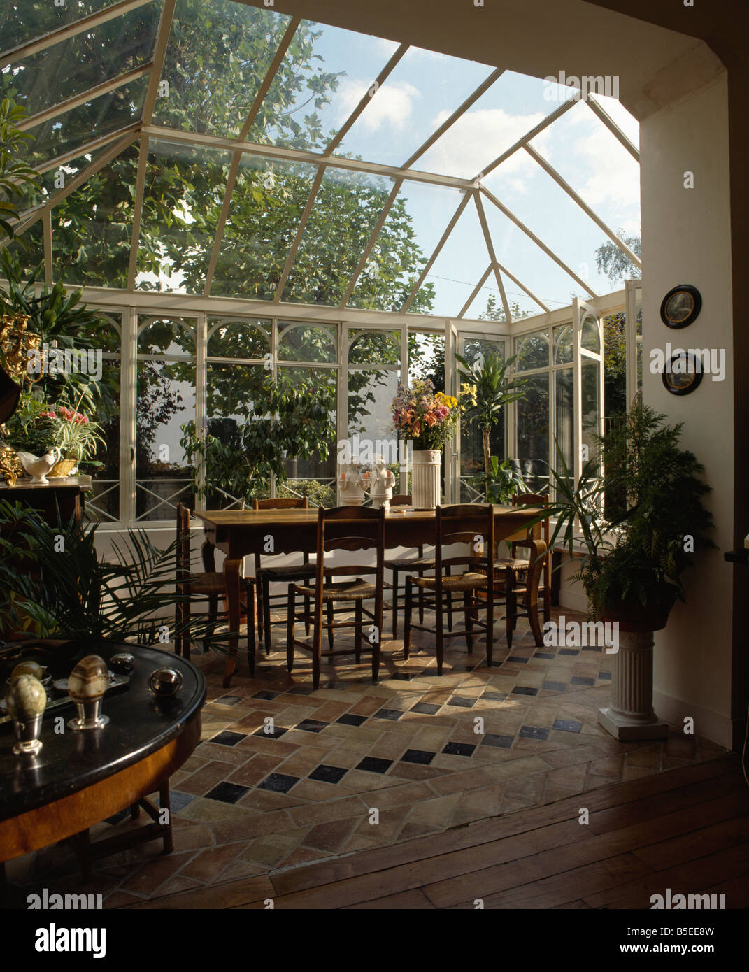 Traditional furniture in conservatory dining room with tiled floor ...