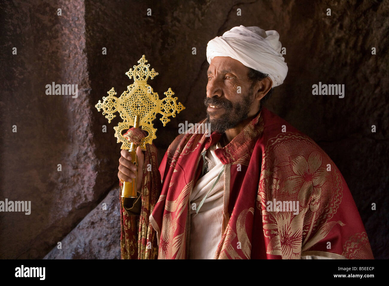 Africa, Ethiopia, Lalibela, Priest in Bet Danaghel Church holding the ...