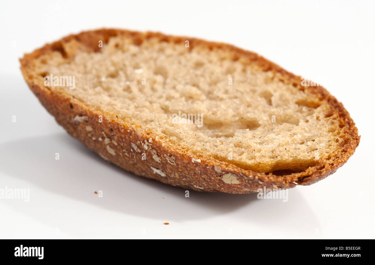 crust of whole wheat bread on light background Stock Photo - Alamy