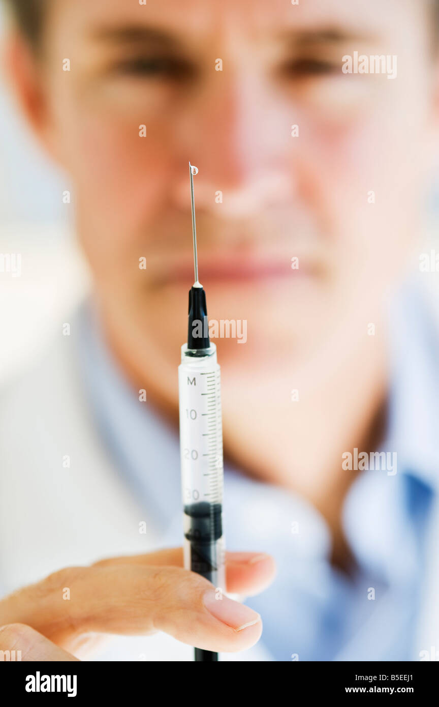 Doctor with syringe Stock Photo - Alamy