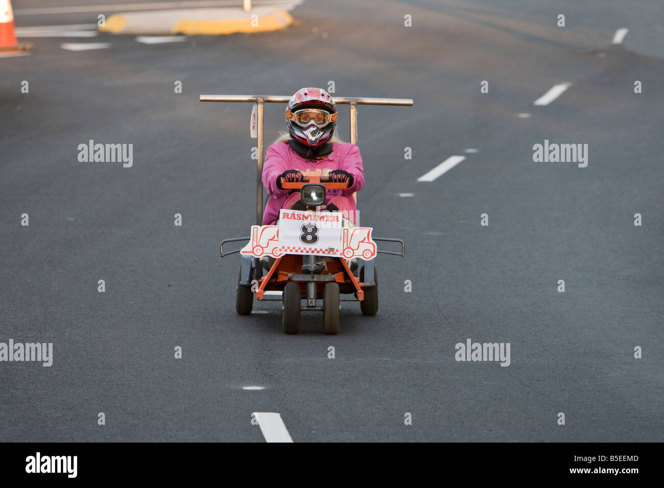 Adult driving home made cart Stock Photo - Alamy