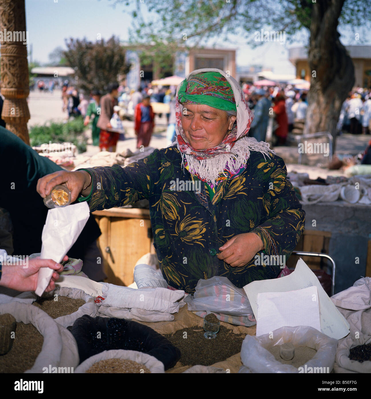 Uzbek woman selling spices in the central market in the city of ...