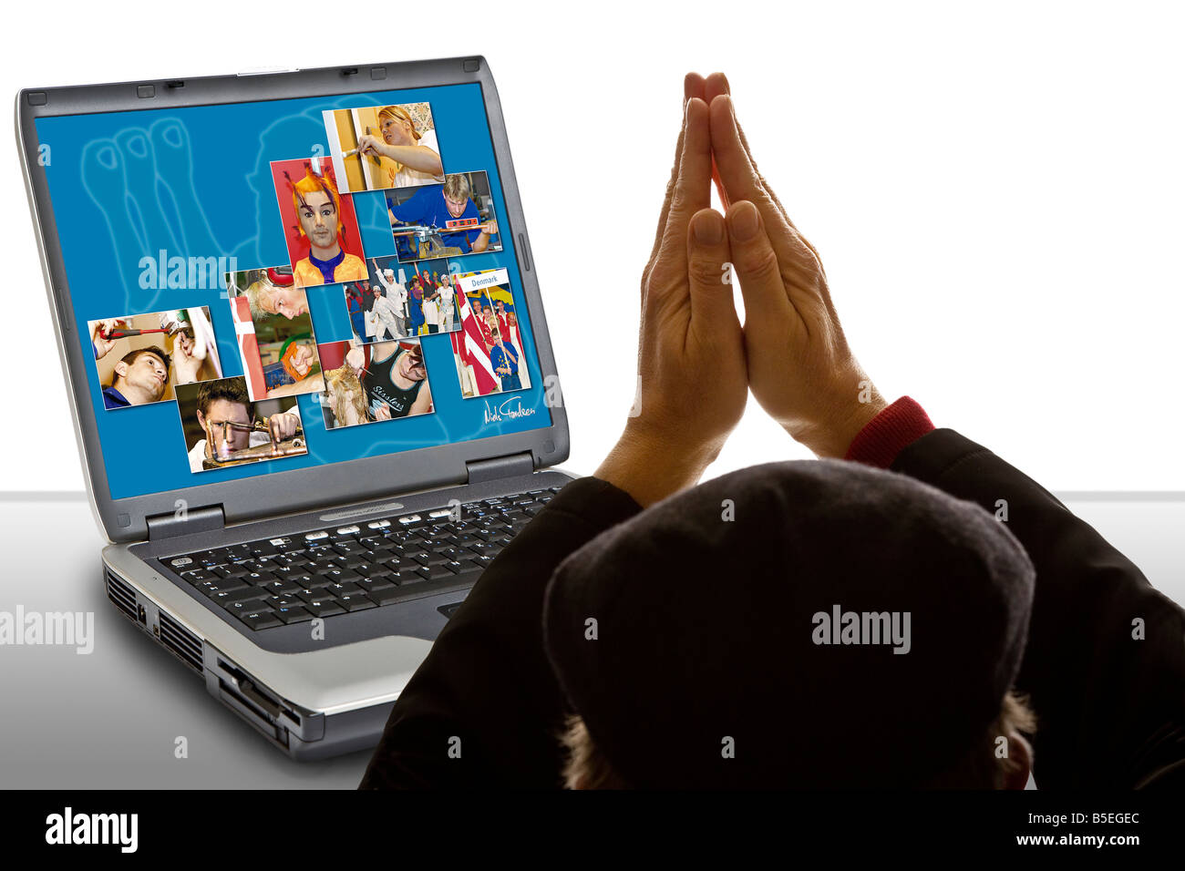 Man praying in front of a portable computer Stock Photo - Alamy