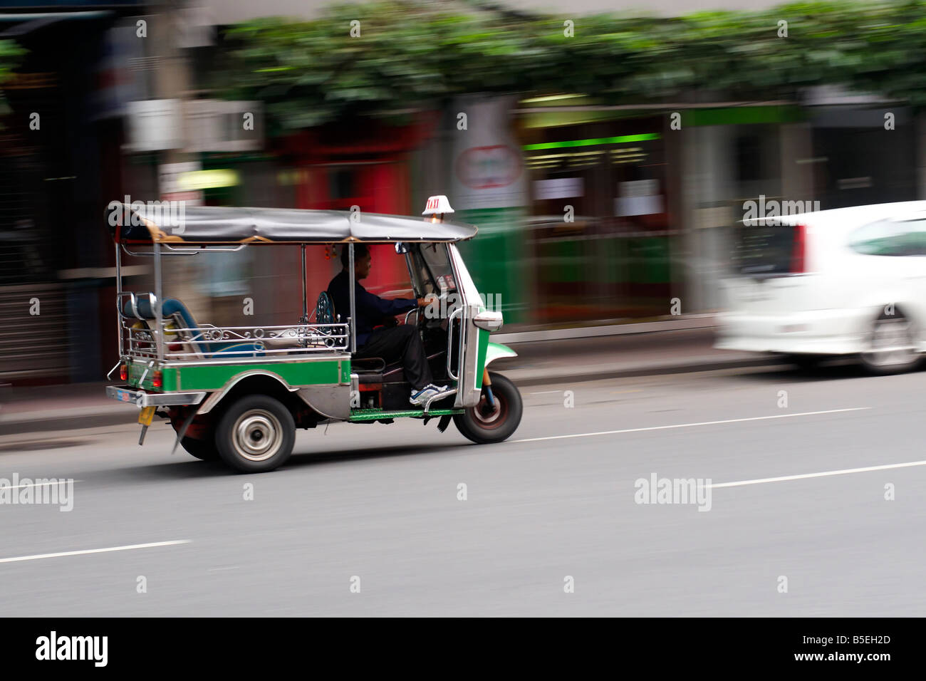 A speeding tuk-tuk in Bangkok, a famous and popular way to explore the ...