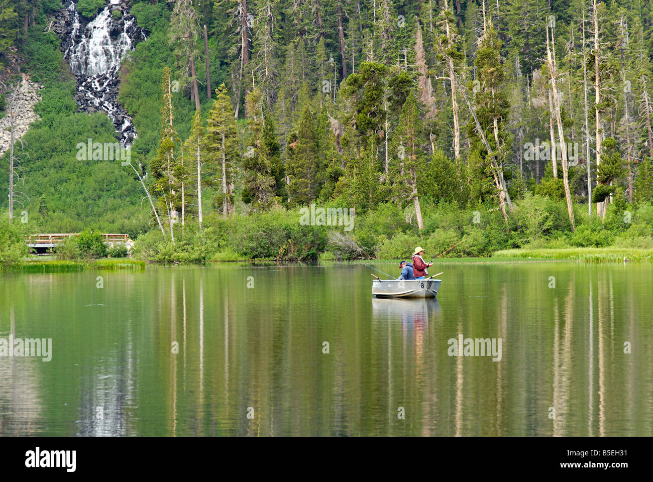 Two people fishing on a lake Stock Photo - Alamy