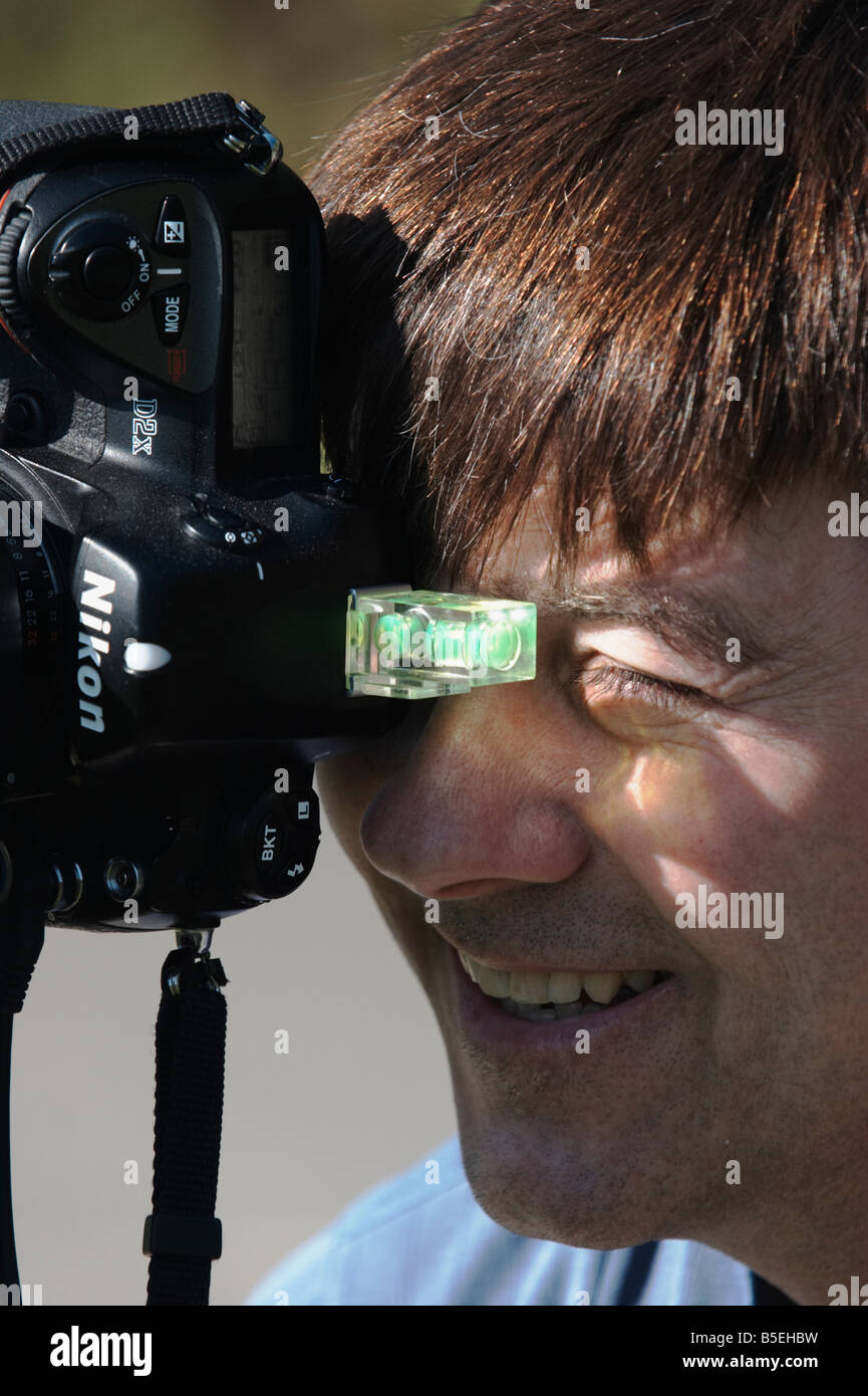 Photographer looking through his camera Stock Photo - Alamy