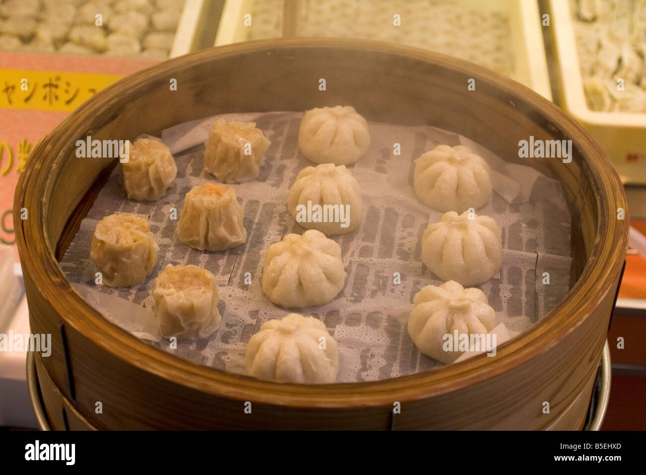 Dumplings steam at a street market in the Tsukiji District of Tokyo ...