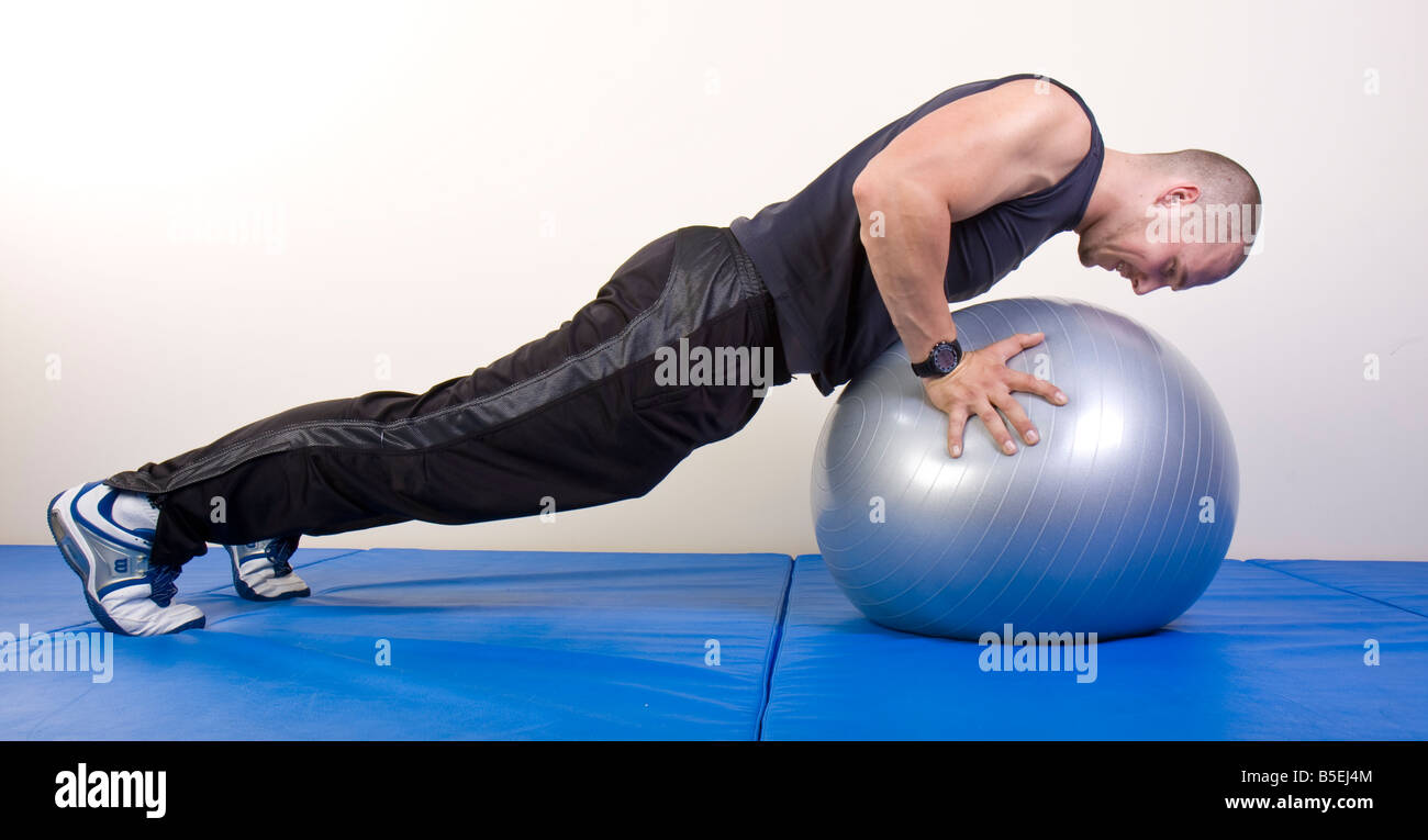 young man doing push-up on Swiss ball Stock Photo - Alamy