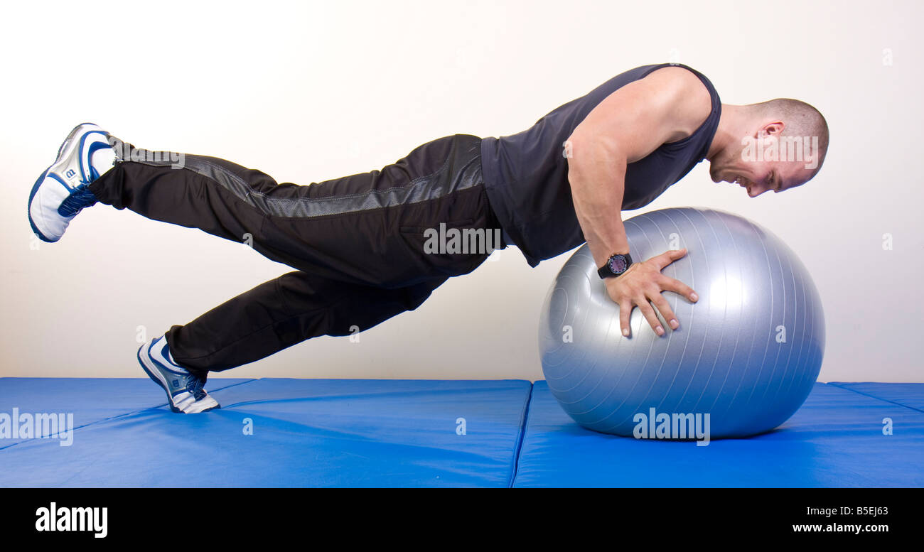 young man doing push-up on Swiss ball Stock Photo - Alamy