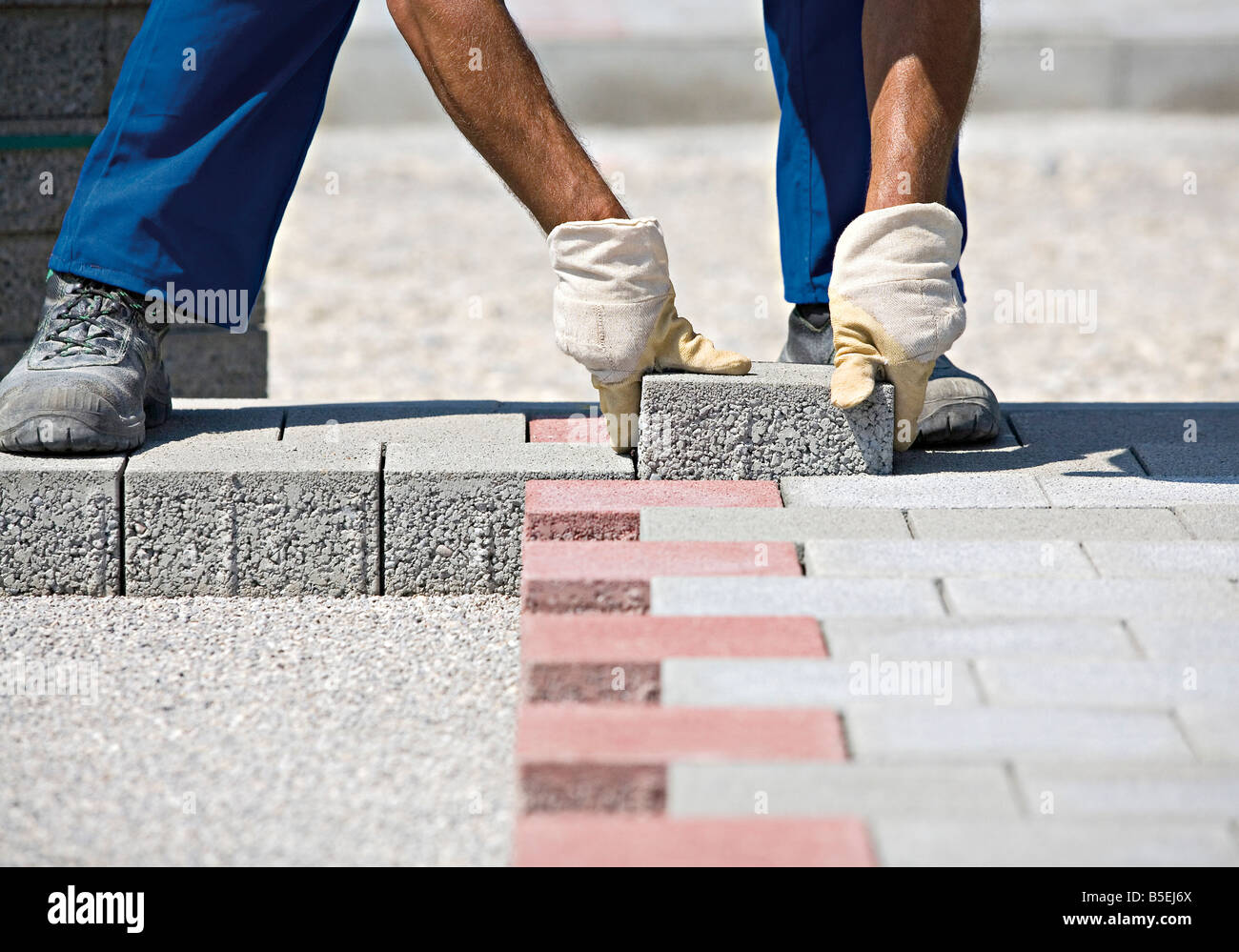 Construction worker setting paving stones Stock Photo - Alamy