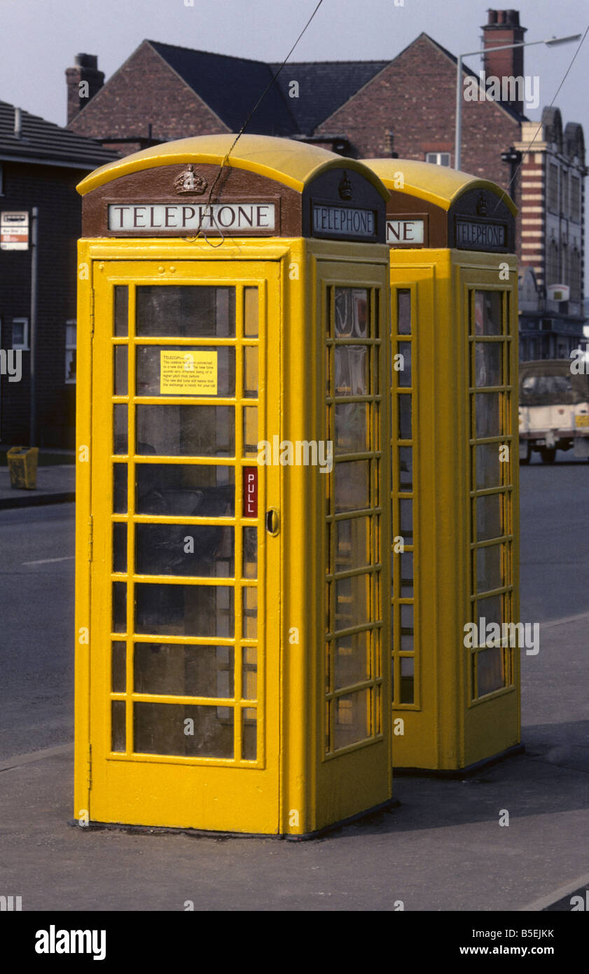 Two standard telephone boxes with 1980s experimental yellow and brown ...