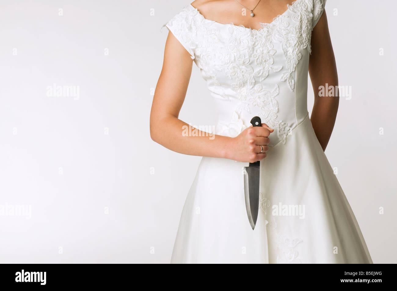 Bride holding knife, mid section Stock Photo - Alamy
