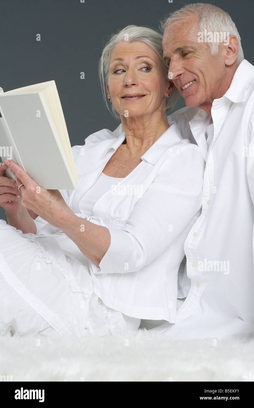 Old couple reading a book Stock Photo - Alamy
